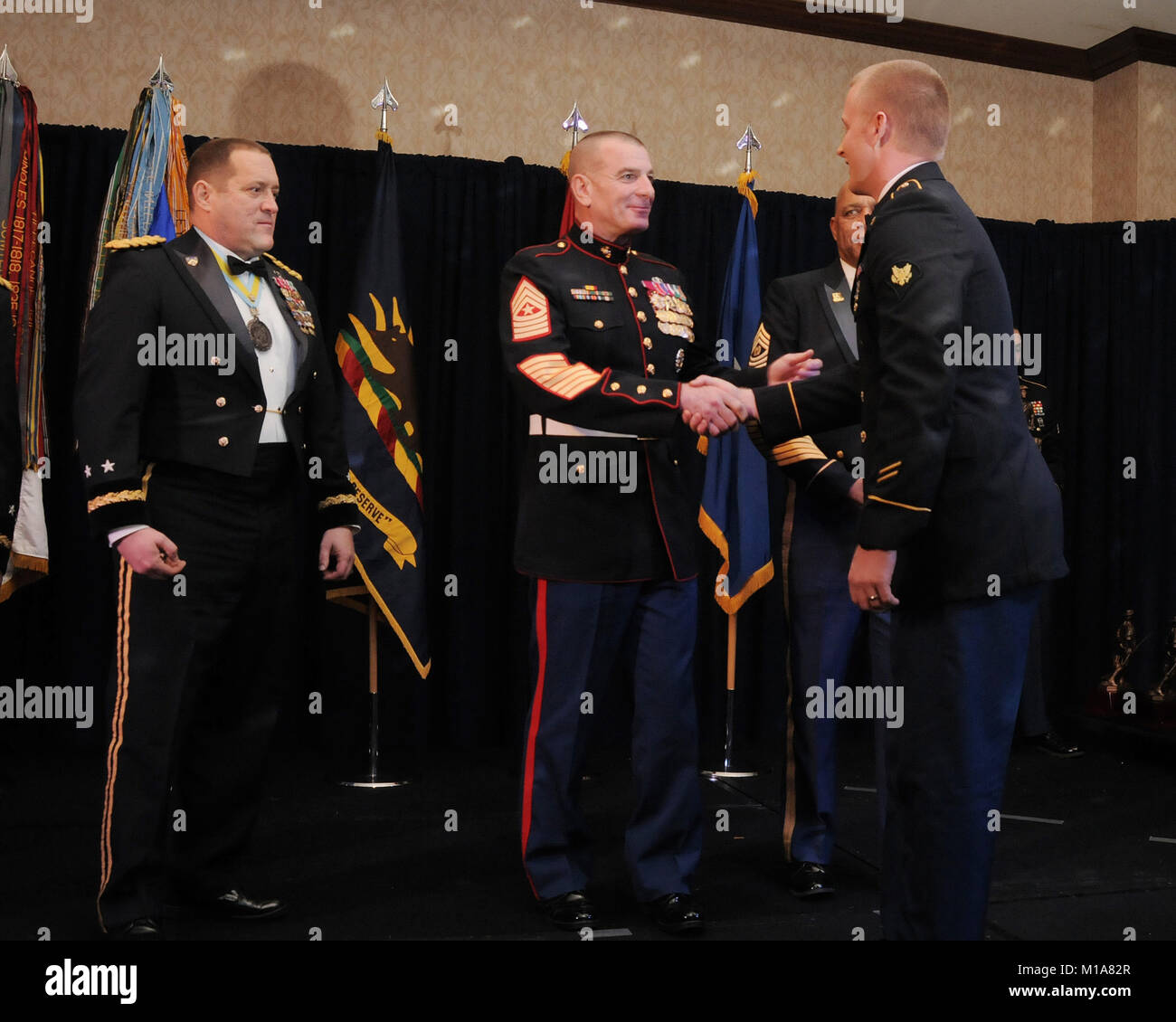 Specialist Ryan Ziegler of the 100th Troop Command is presented the ...