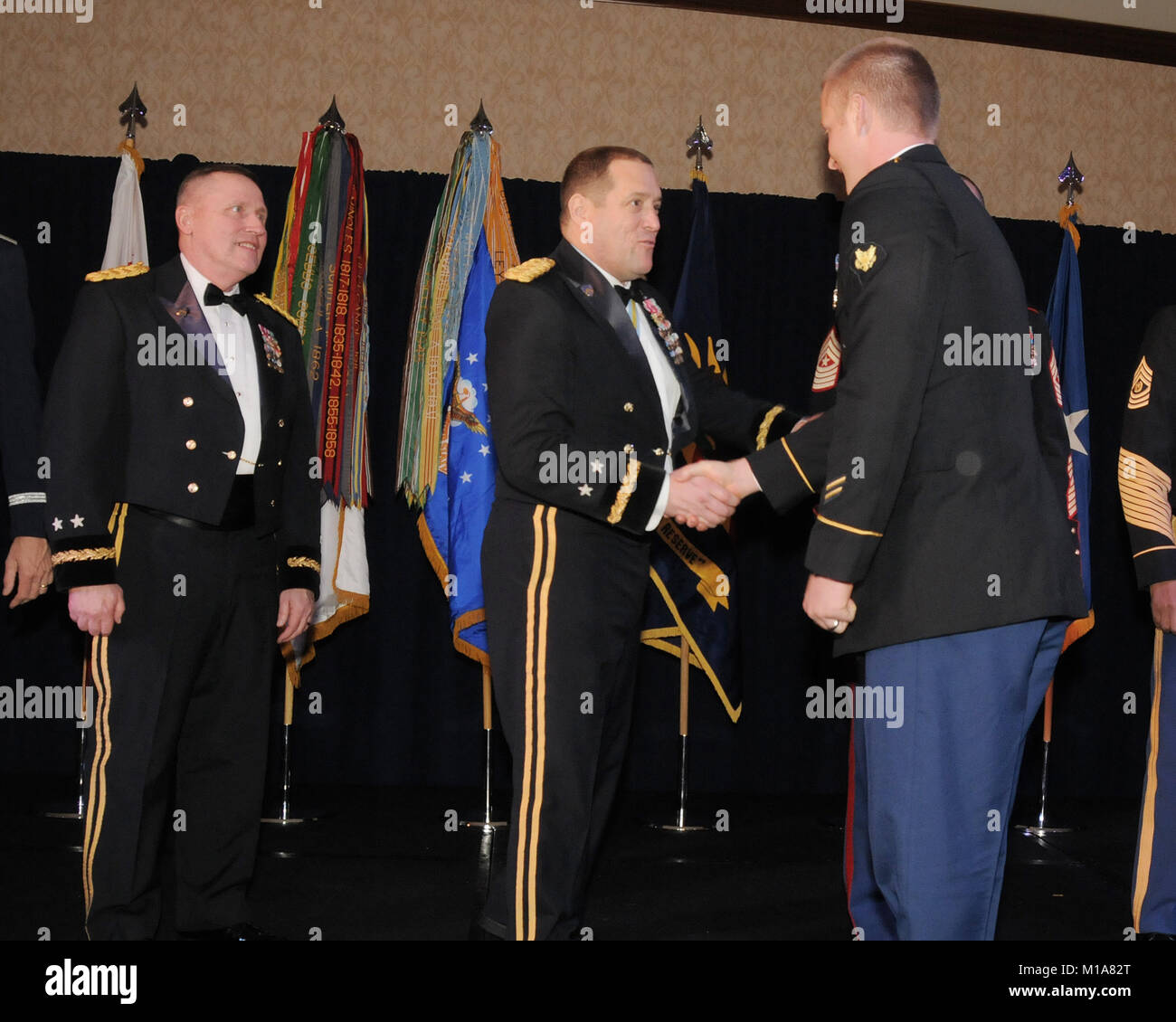 Specialist Ryan Ziegler of the 100th Troop Command is presented the ...