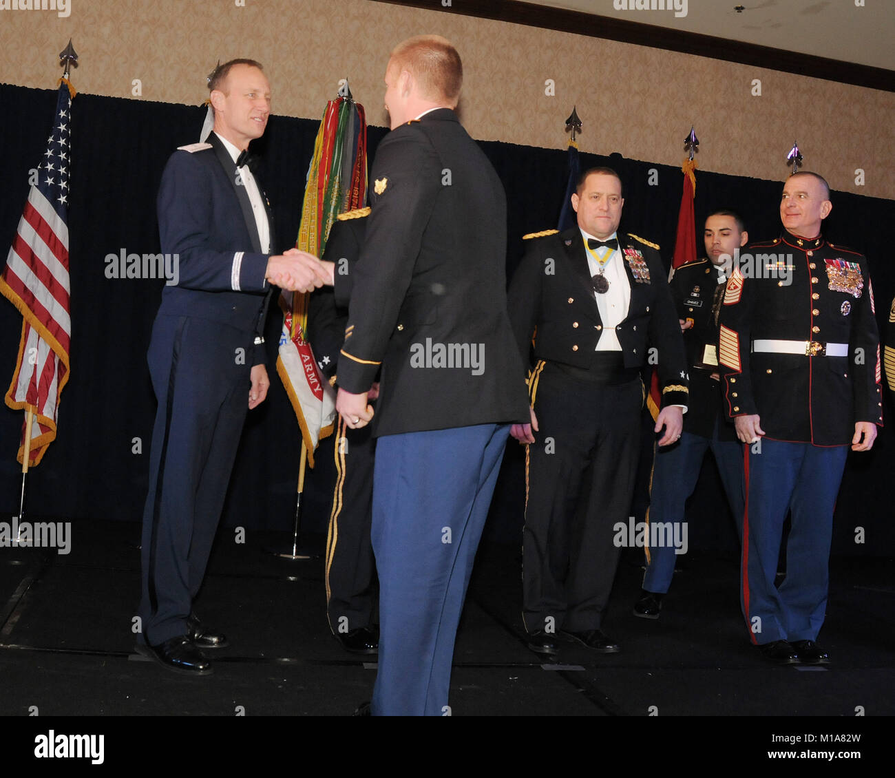 Specialist Ryan Ziegler of the 100th Troop Command is presented the ...