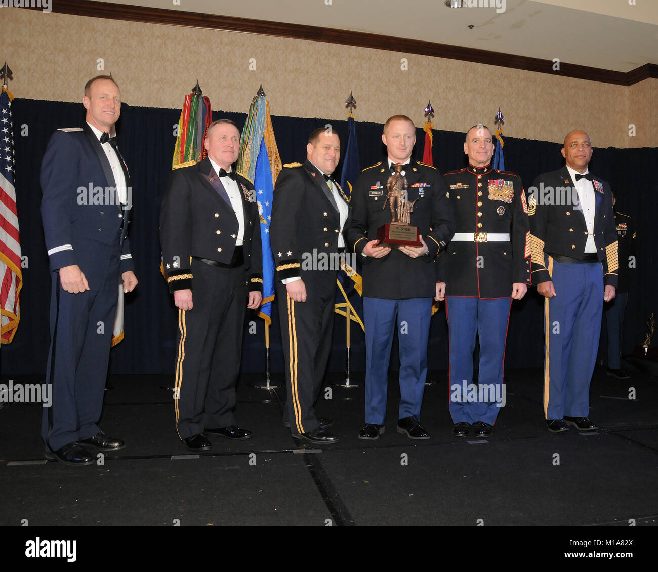Specialist Ryan Ziegler of the 100th Troop Command is presented the ...