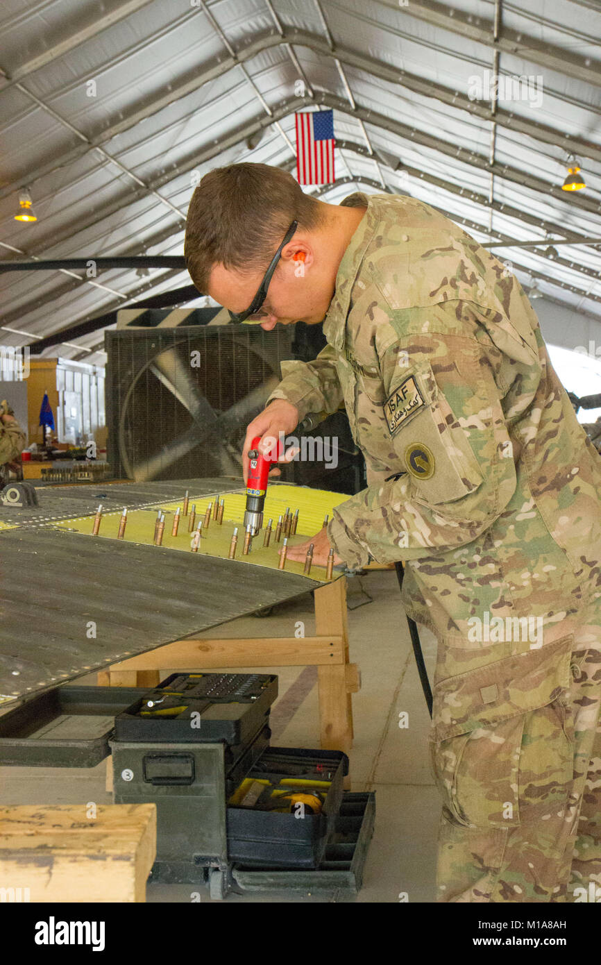 Army Spc. Samuel Miller, from Ahwahnee, Calif., fastens rivets to a ...