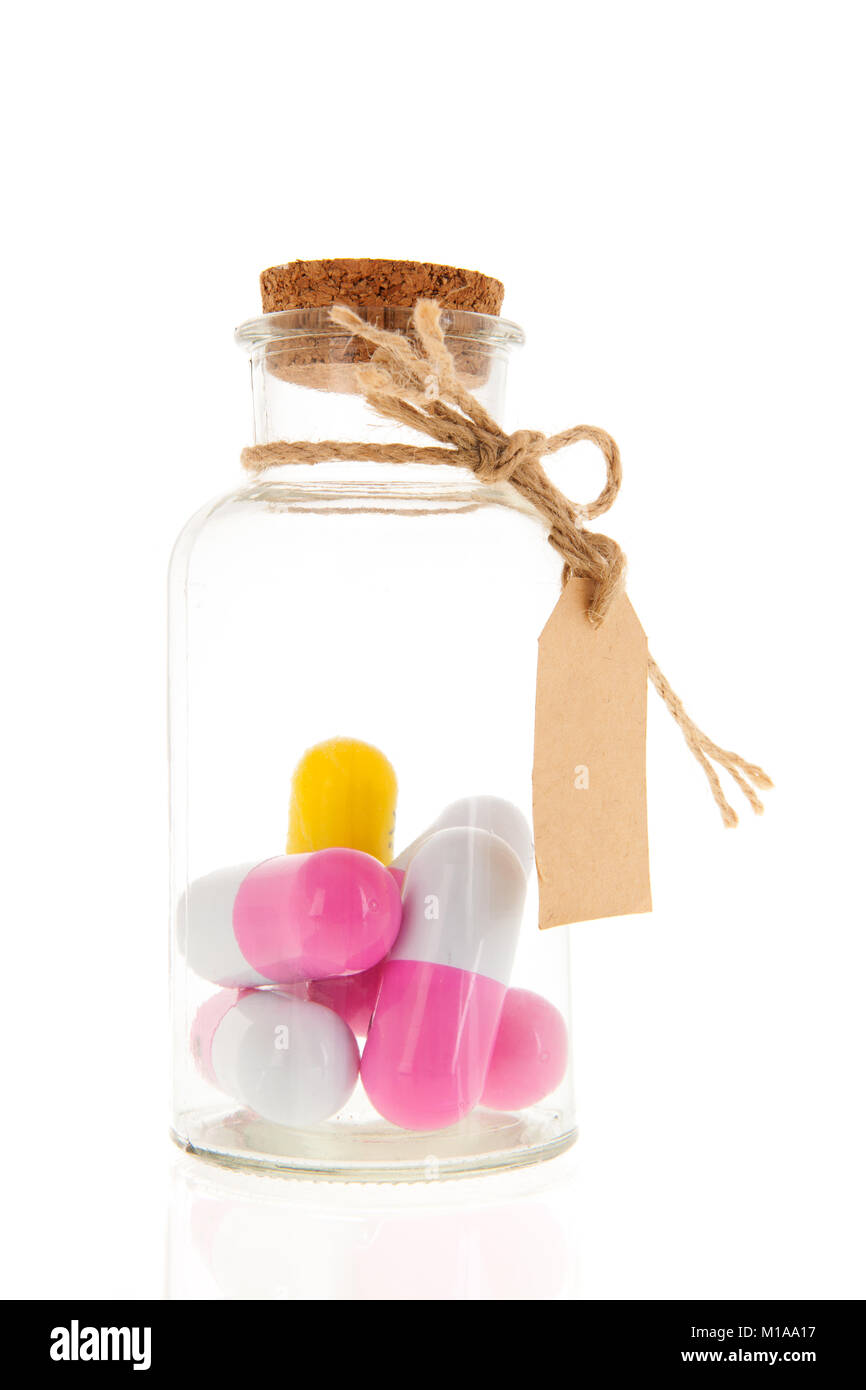 Pot medicine capsules isolated over white background Stock Photo - Alamy