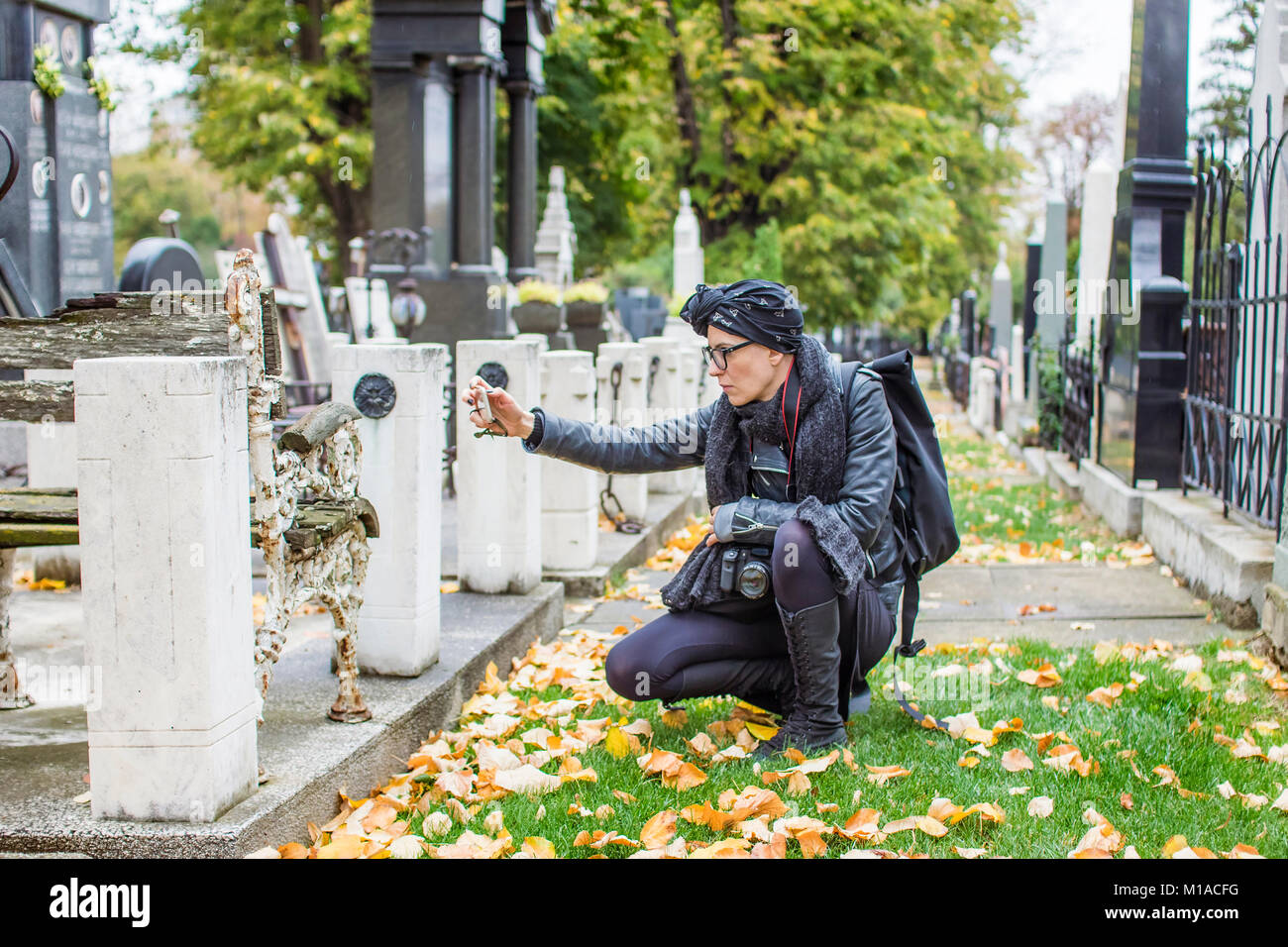 Woman photographer taking pictures at the graveyard Stock Photo - Alamy