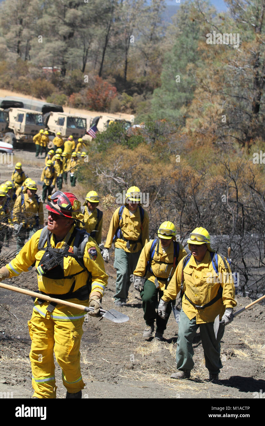 CAL FIRE Capt. Joaquin Silos, red helmet, leads members of Crew 09 ...