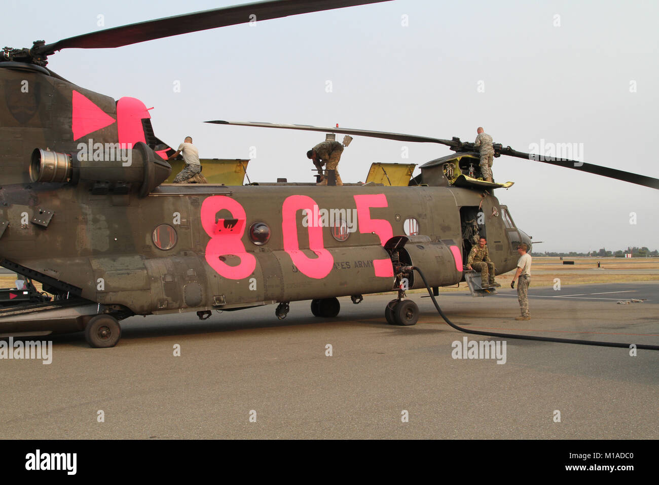 Mechanics and crew members of a CH-47 Chinook from the California Army ...