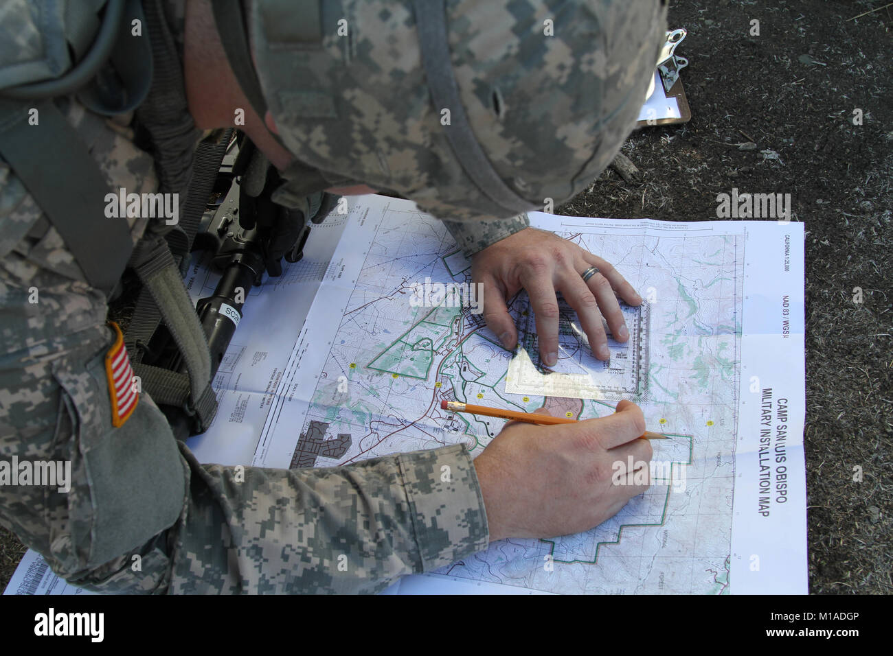 Sgt. Lander Beyer, 240th Signal Battalion, reads a map and plots ...