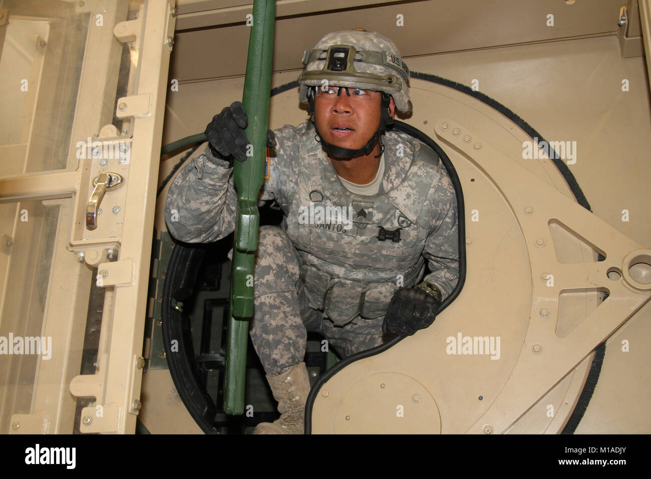 Sgt. Wiljohn Santos, 40th Infantry Division, exits a Humvee simulator ...