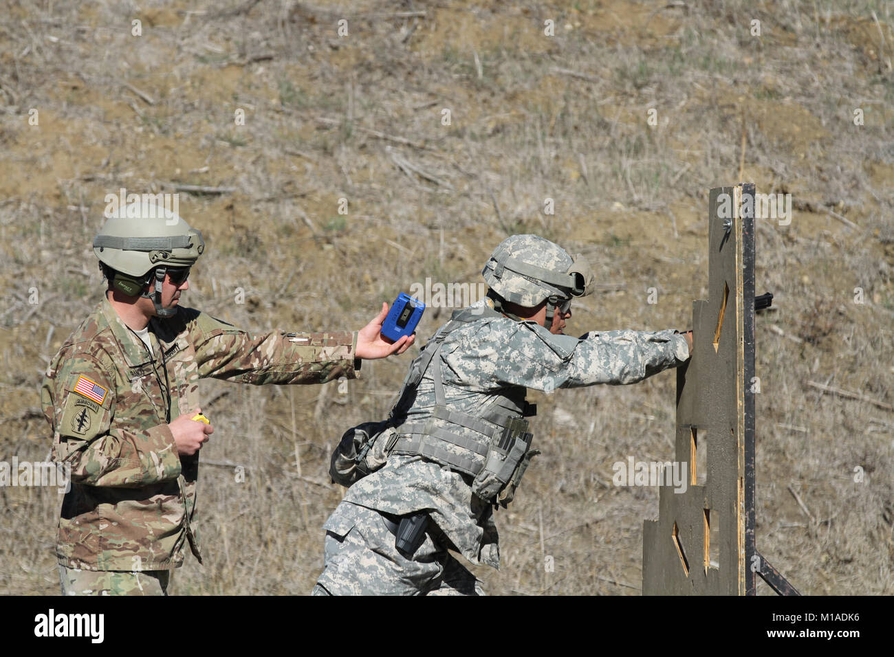Spc. Jeremy Granados, 100th Troop Command, right, is monitored by range ...