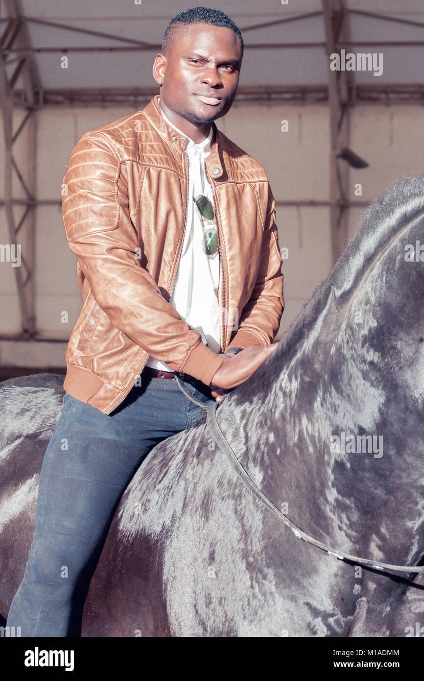 man riding brown horse on countryside Stock Photo - Alamy