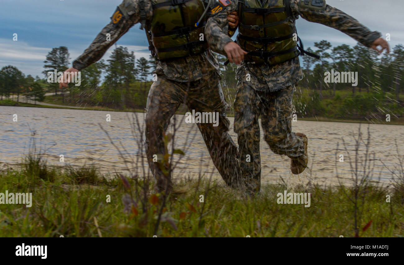 U.S. Army Sgt. 1st Class Jonathan Knea (left) helps his teammate, Staff ...