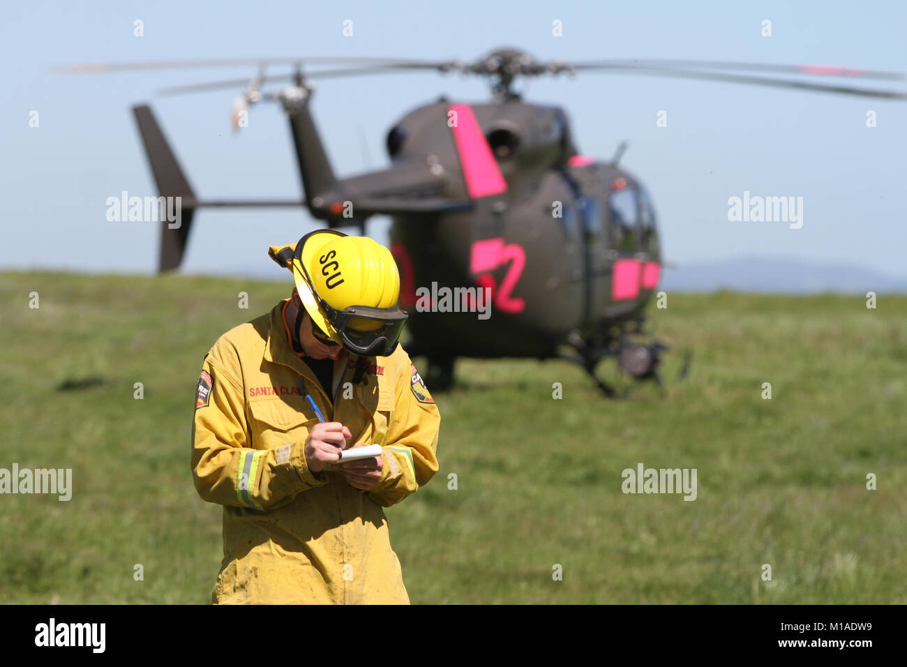 Firefighter Nelson Reid of CAL FIRE checks his notes in front of a ...