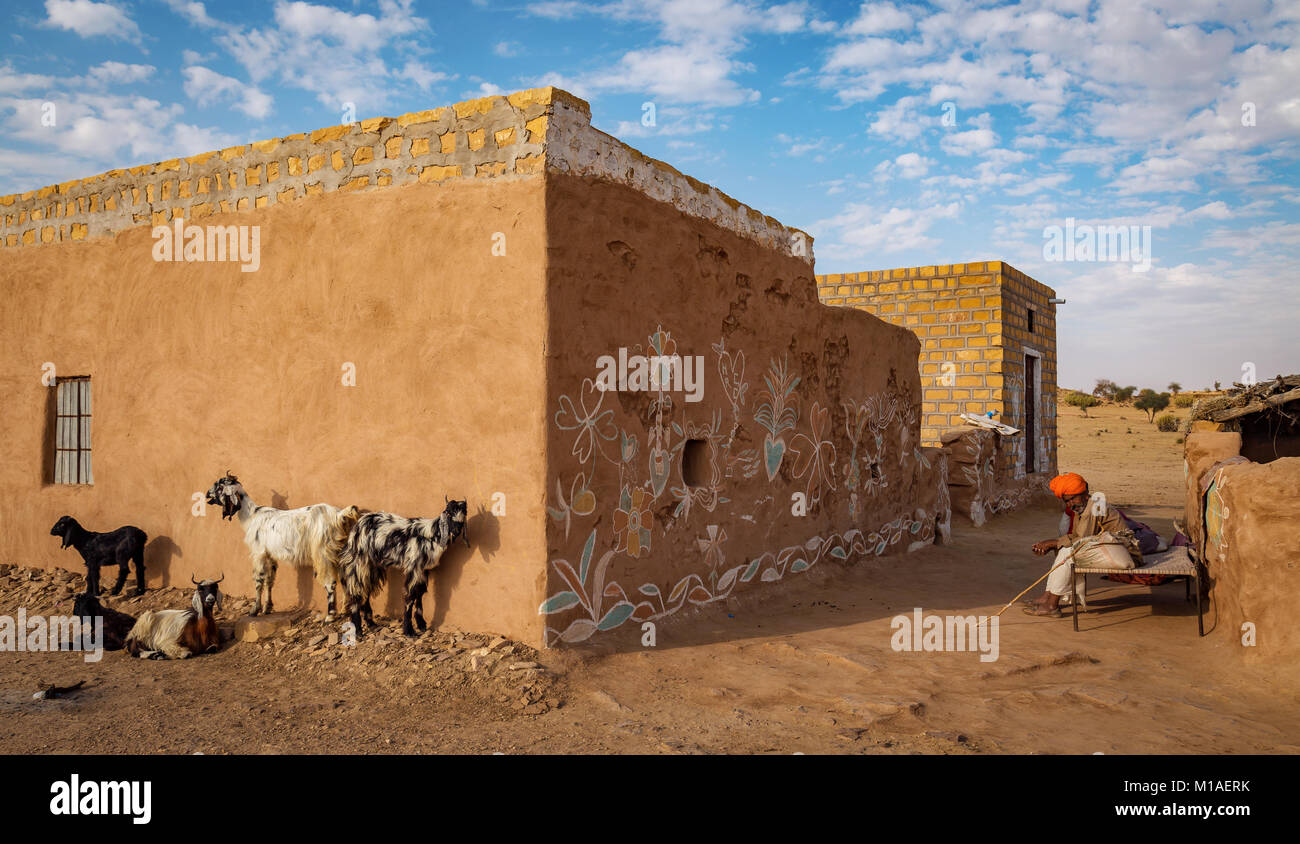 Rajasthani man sitting in an alleyway at a rural village near Thar ...