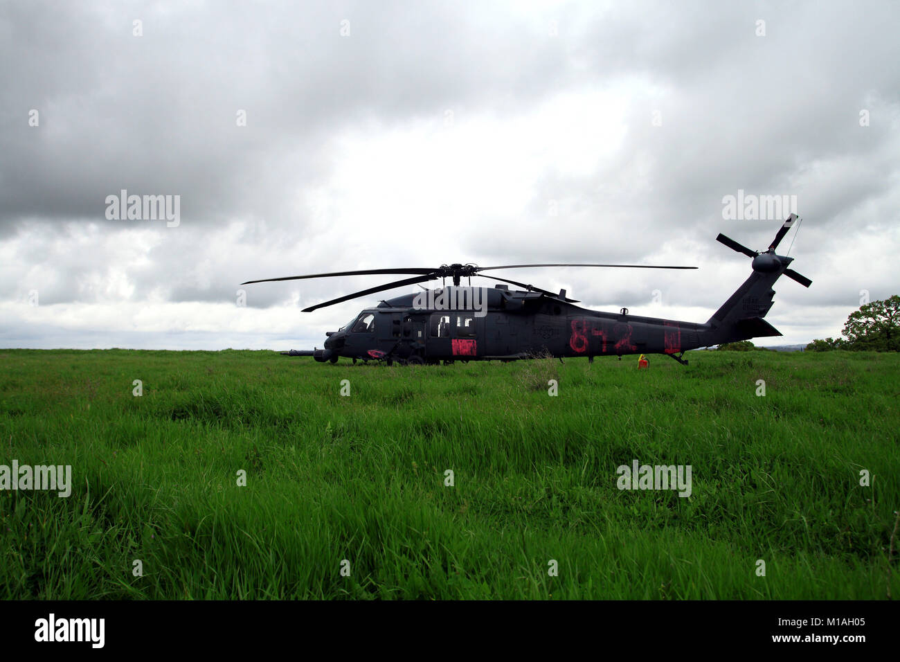 A storm rolls in beyond an HH-60G Pave Hawk helicopter from the 129th ...