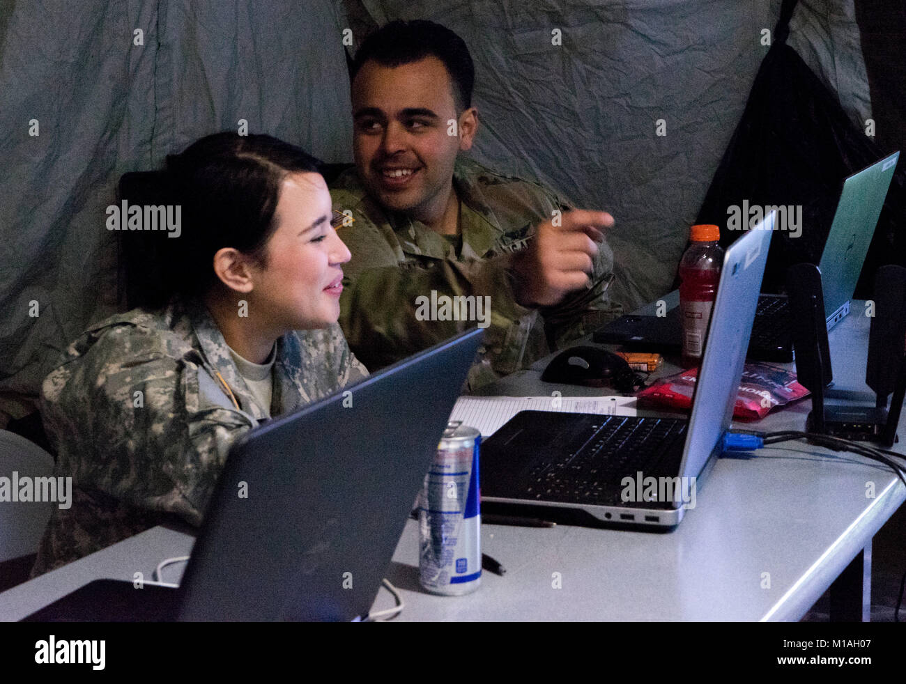 Soldiers inside the temporary tactical operations center (TOC) review ...