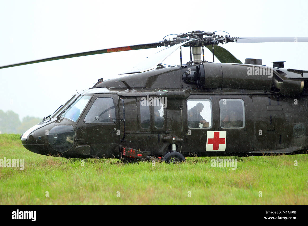 An aircrew waits out a storm from inside an HH-60L Black Hawk ...