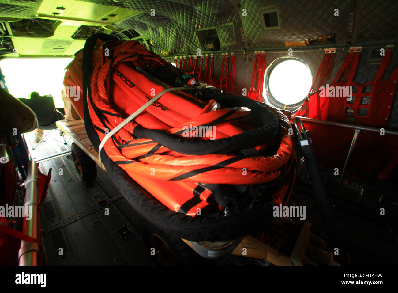 A Bambi Bucket is loaded inside a CH-47F Chinook helicopter operated by ...