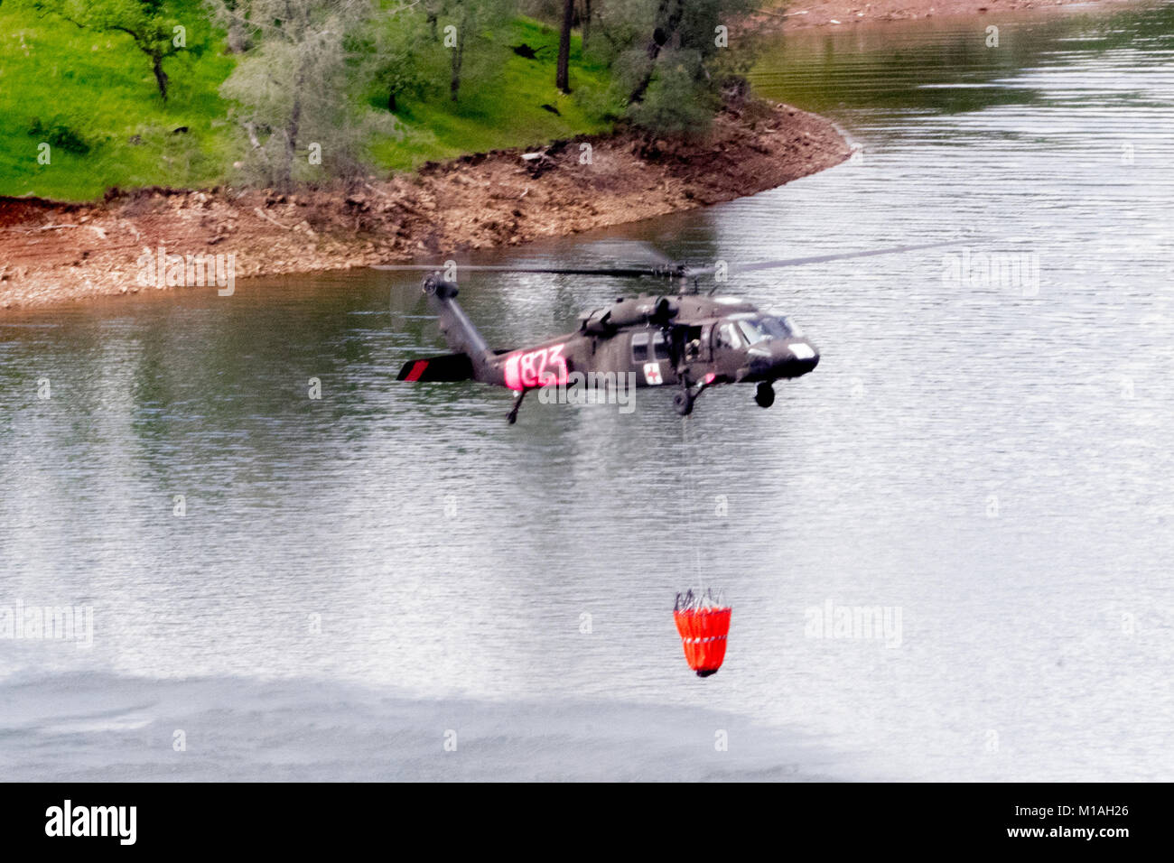 A UH-60 Black Hawk helicopter collects water from Pardee Reservoir on ...