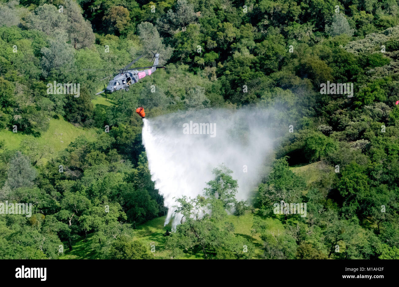 A UH-60 Black Hawk unloads water over a drop zone near Ione, April 8 ...