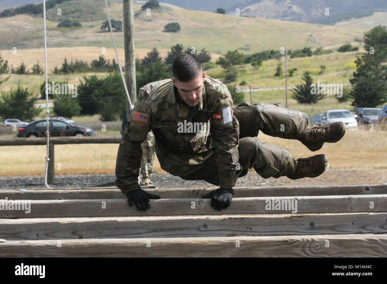 Nevada Army National Guardsman Spc. Grant Reimers hurdles through side ...