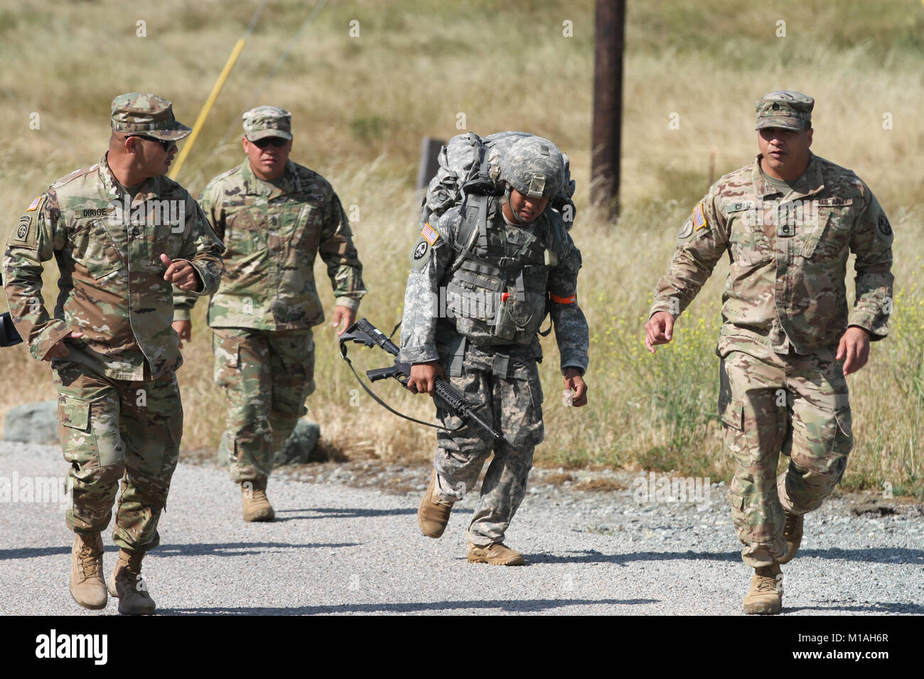 Sgt. Jacob T. Penaflor, center, of the Guam Army National Guard, gets ...