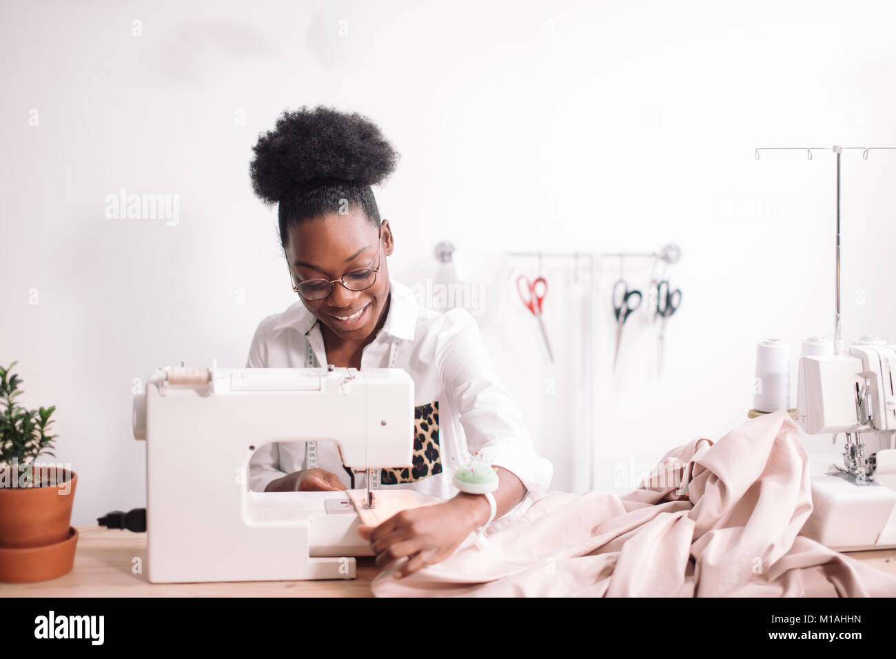 african seamstress sews clothes Stock Photo - Alamy
