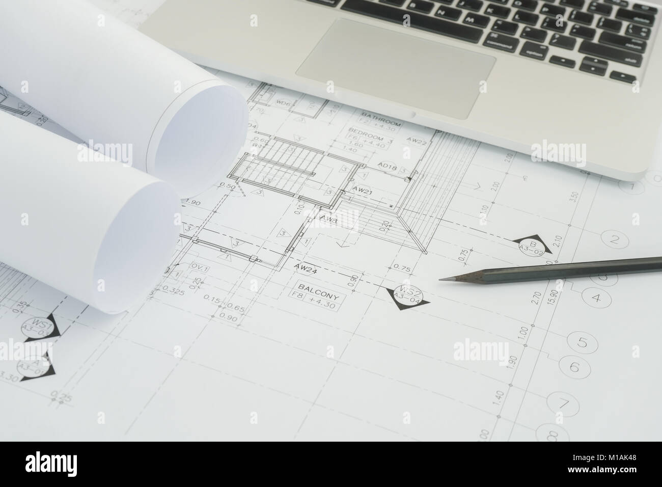 black pencil and computer laptop on architectural drawing paper for ...