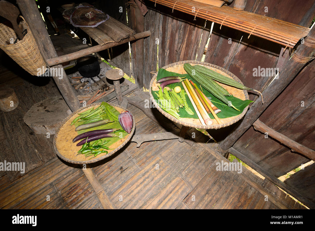 Trays of vegetables displayed in a traditional longhouse, Mari Mari ...