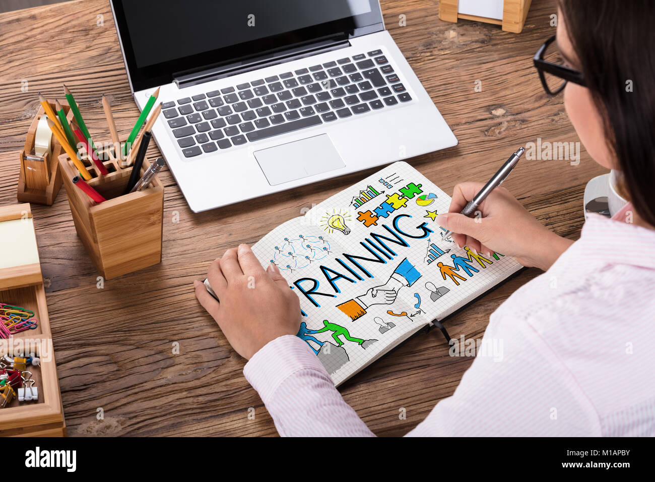Businesswoman Drawing Training Plan On Notebook At Workplace Stock ...