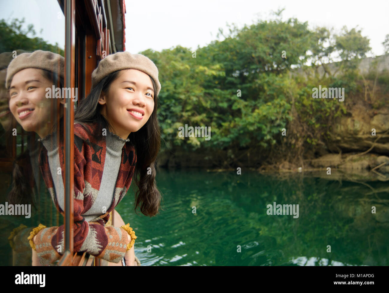Girl enjoying the ride on a wooden tourist boat Stock Photo - Alamy