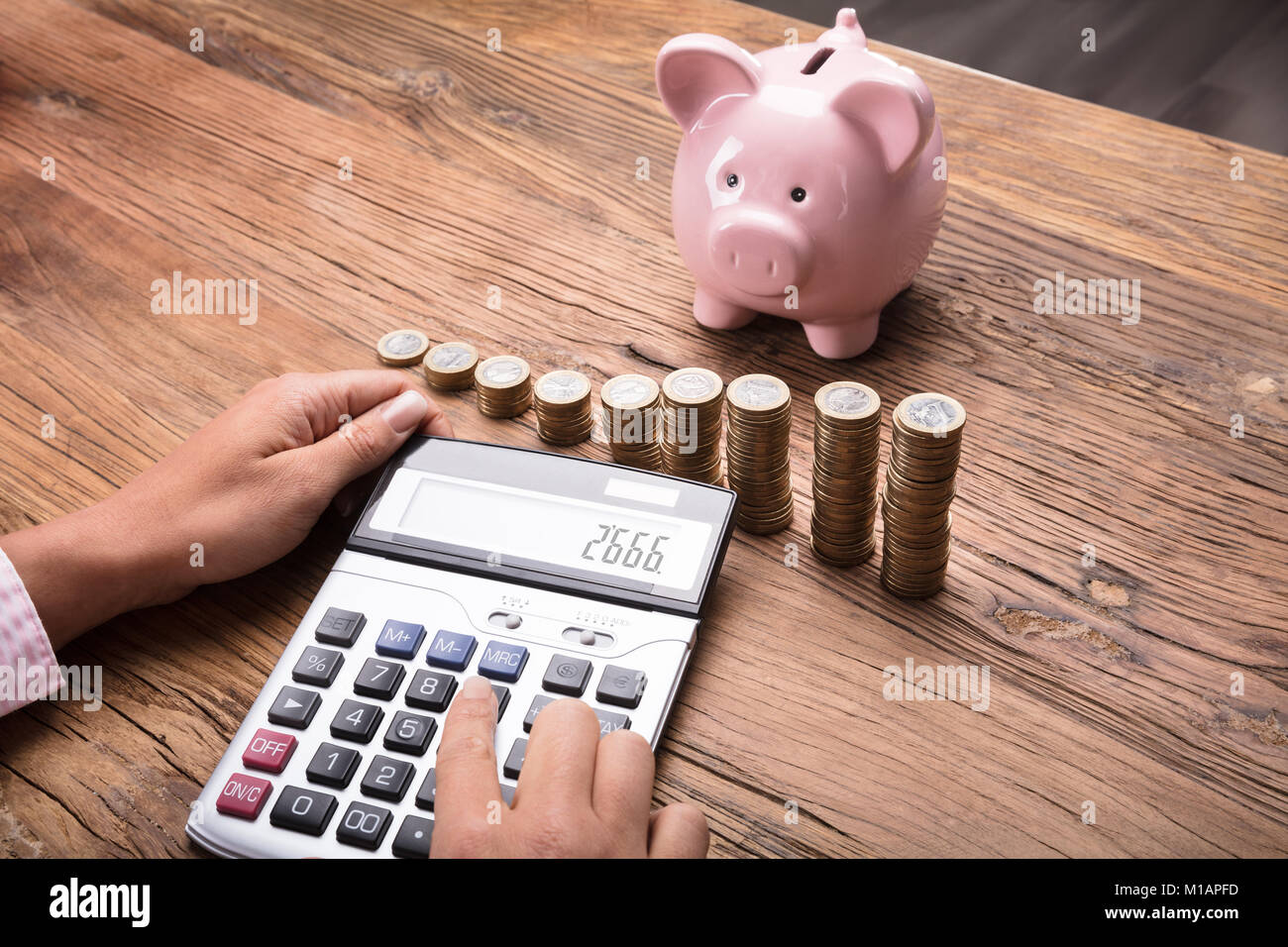 Woman Calculating Finances Using Calculator On Wooden Desk Stock Photo ...