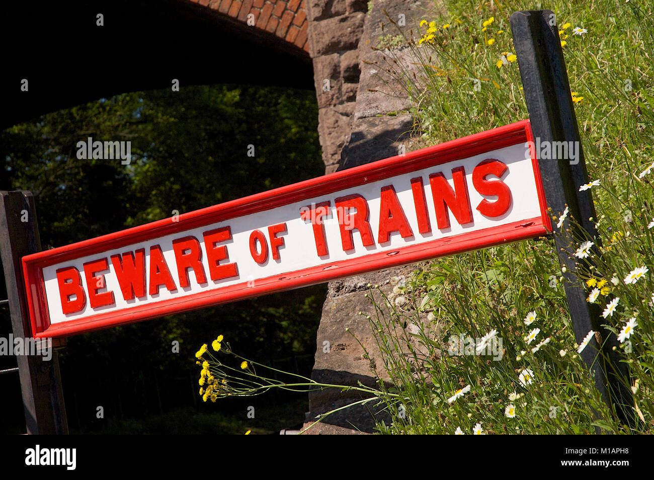 Beware of Trains sign on a heritage railway Stock Photo - Alamy