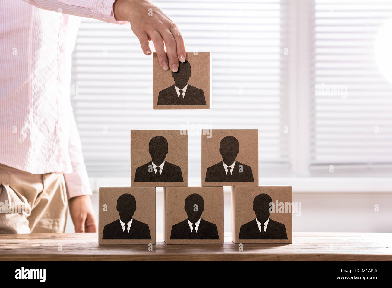 Close-up Of A Businesswoman Making A Business Team Pyramid On Desk In ...