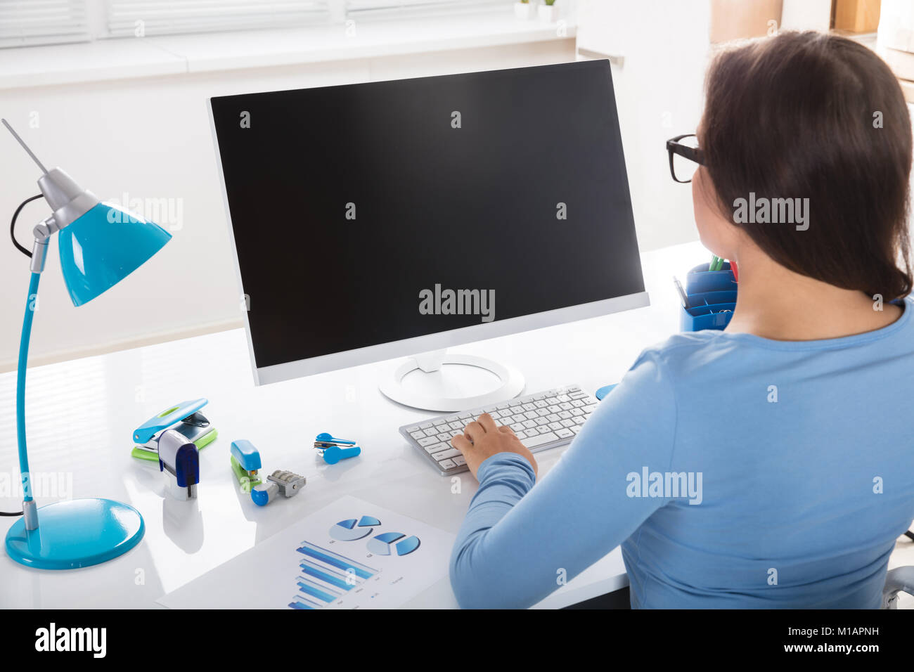 Rear View Of A Businesswoman Using Computer On Desk Stock Photo - Alamy