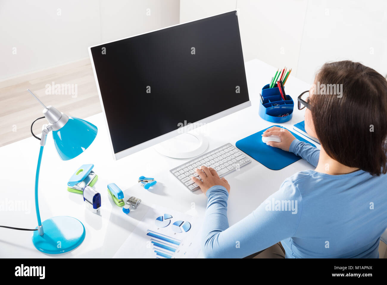 Rear View Of A Businesswoman Using Computer On Desk Stock Photo - Alamy