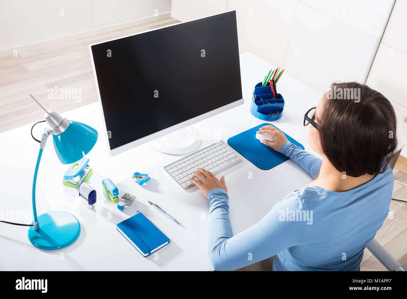 Rear View Of A Businesswoman Using Computer On Desk Stock Photo - Alamy