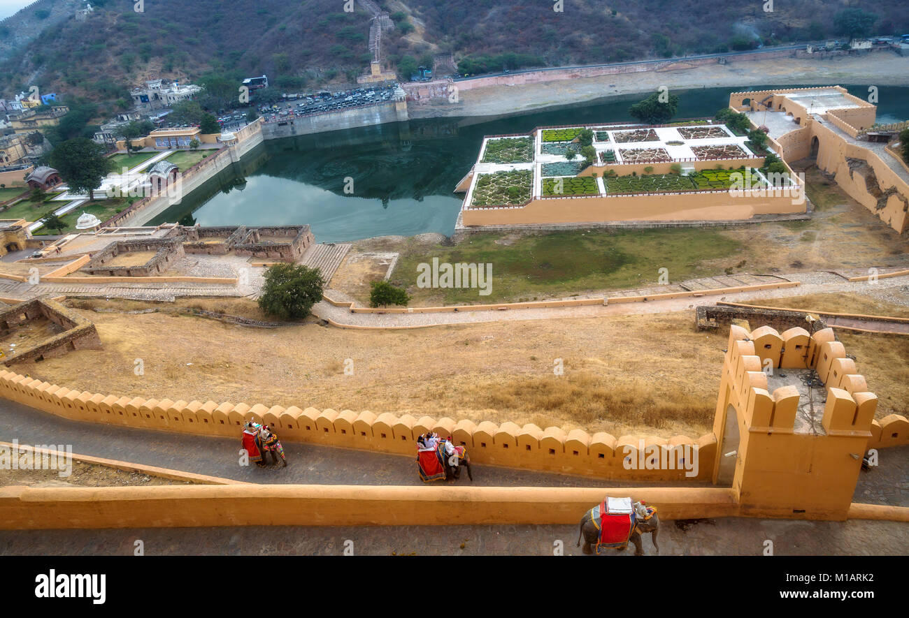 Aerial view of fort gate and tourists on elephants with distant ...