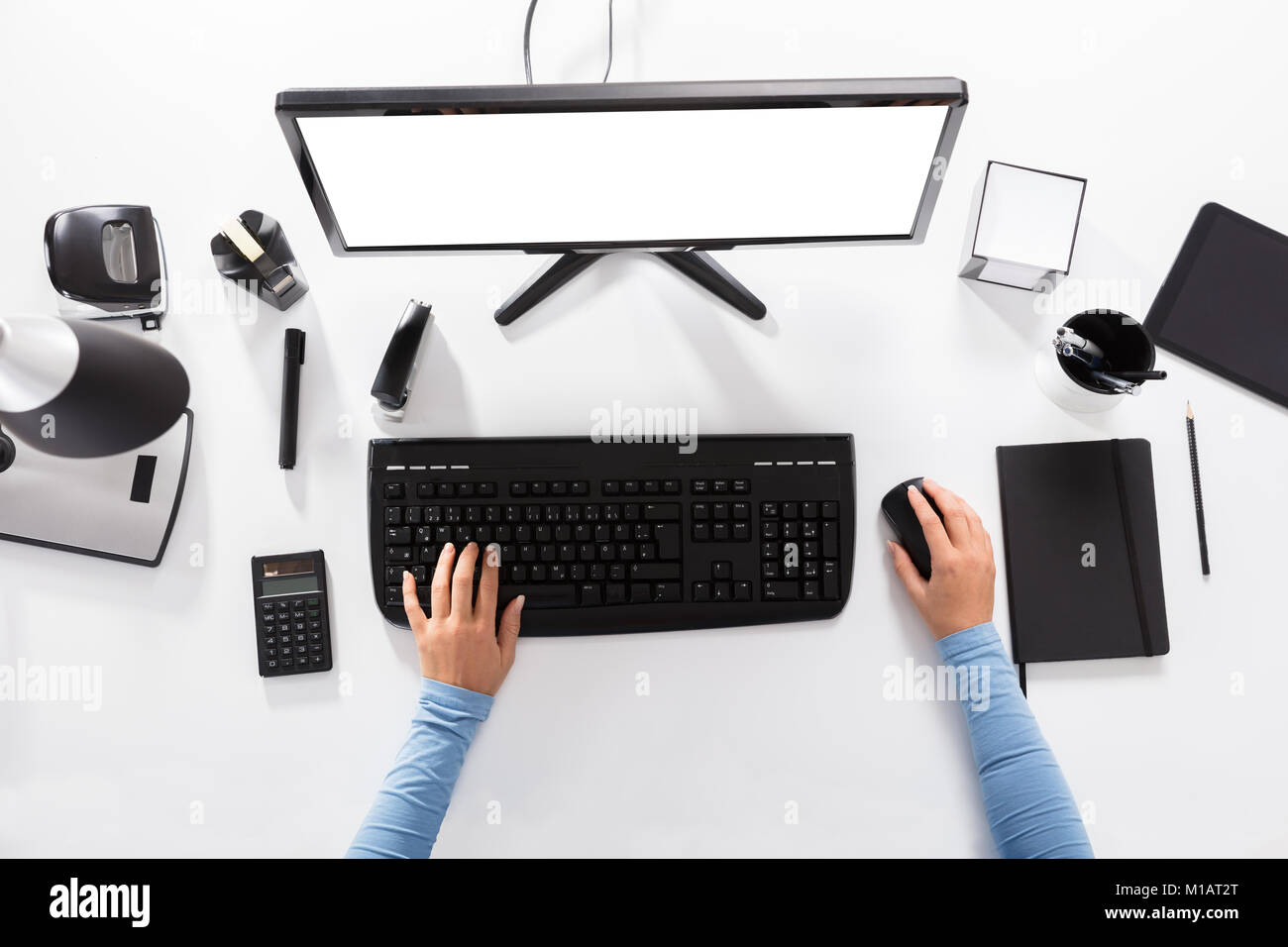 Close-up Of A Businesswoman Using Computer With Blank Screen On Desk In ...