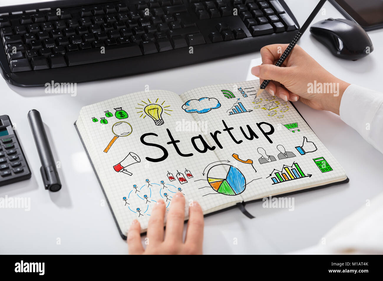 Close-up Of A Businesswoman Drawing Start Up Chart On Notebook Over ...