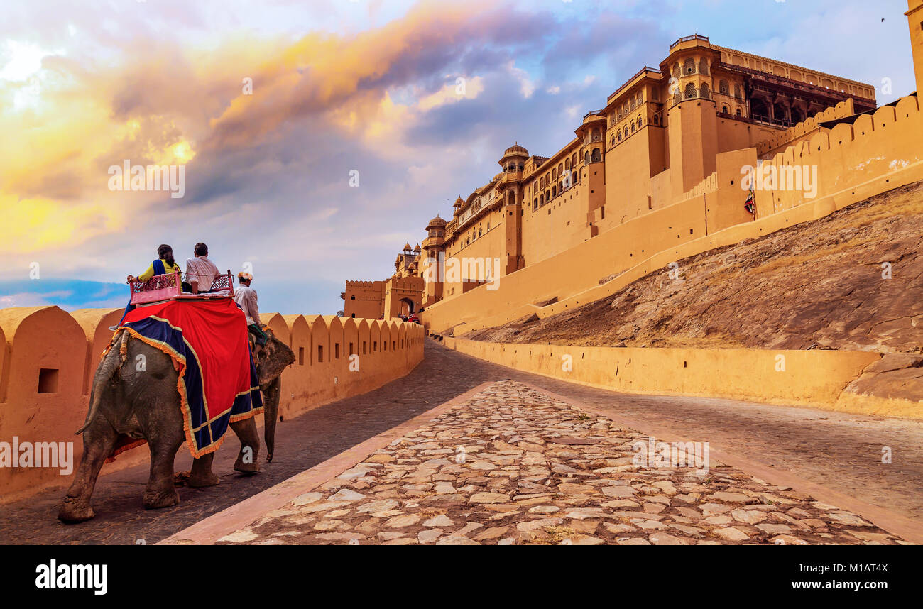 Tourists enjoy elephant ride at sunset at the historic Amer Fort (Amber ...
