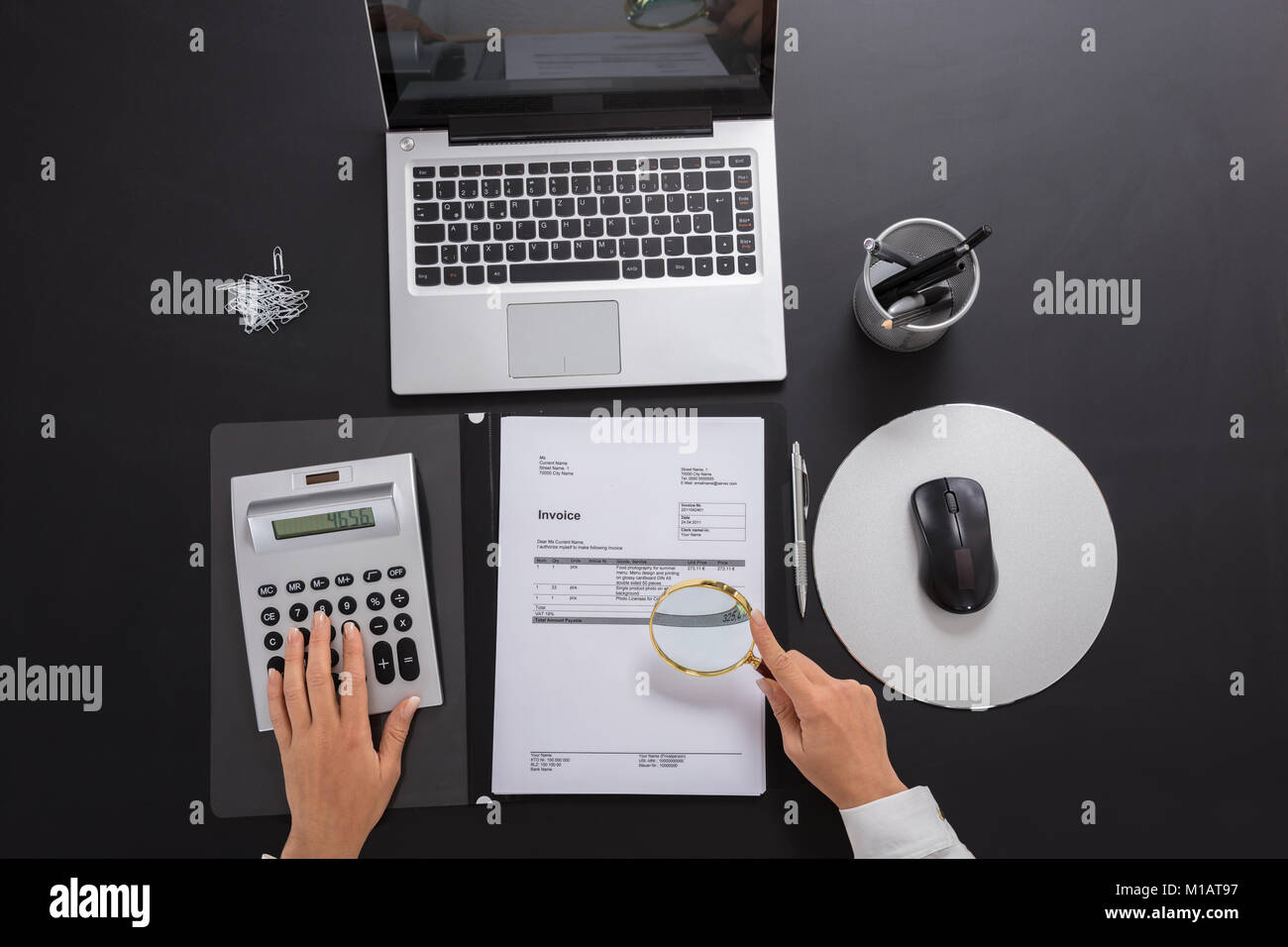 Close-up Of A Businesswoman Looking Invoice Through Magnifying Glass ...