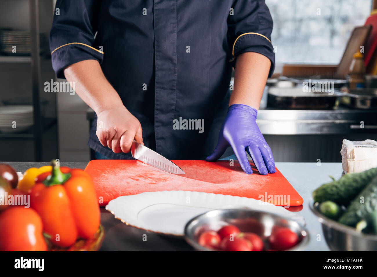cropped shot of chef with knife at workplace in restaurant Stock Photo ...