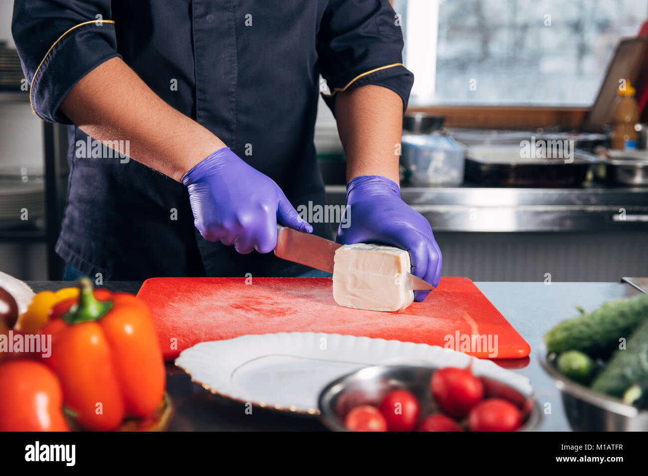 cropped shot of chef slicing cheese at kitchen Stock Photo - Alamy