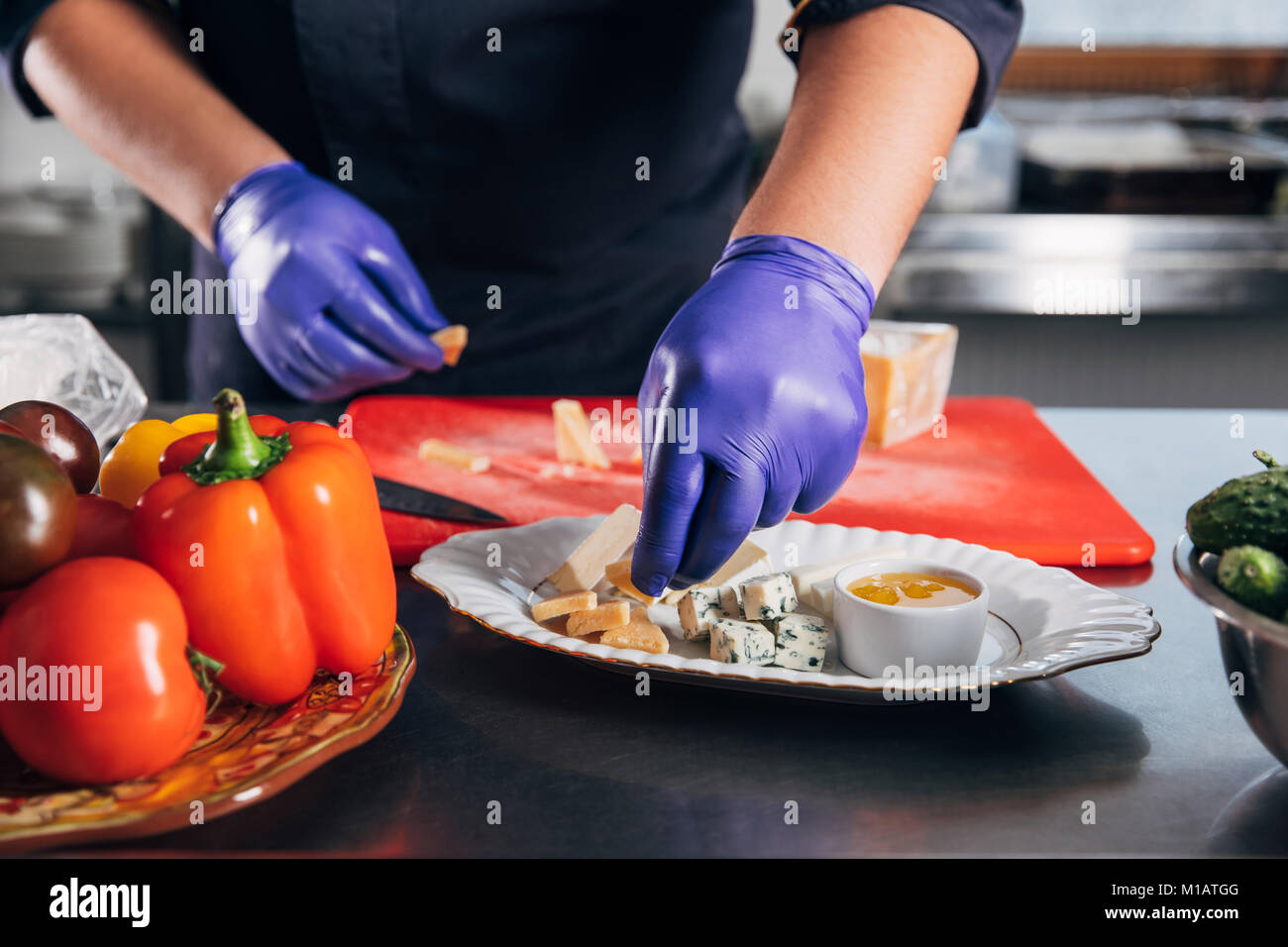 cropped shot of chef putting cheese slices on plate Stock Photo - Alamy