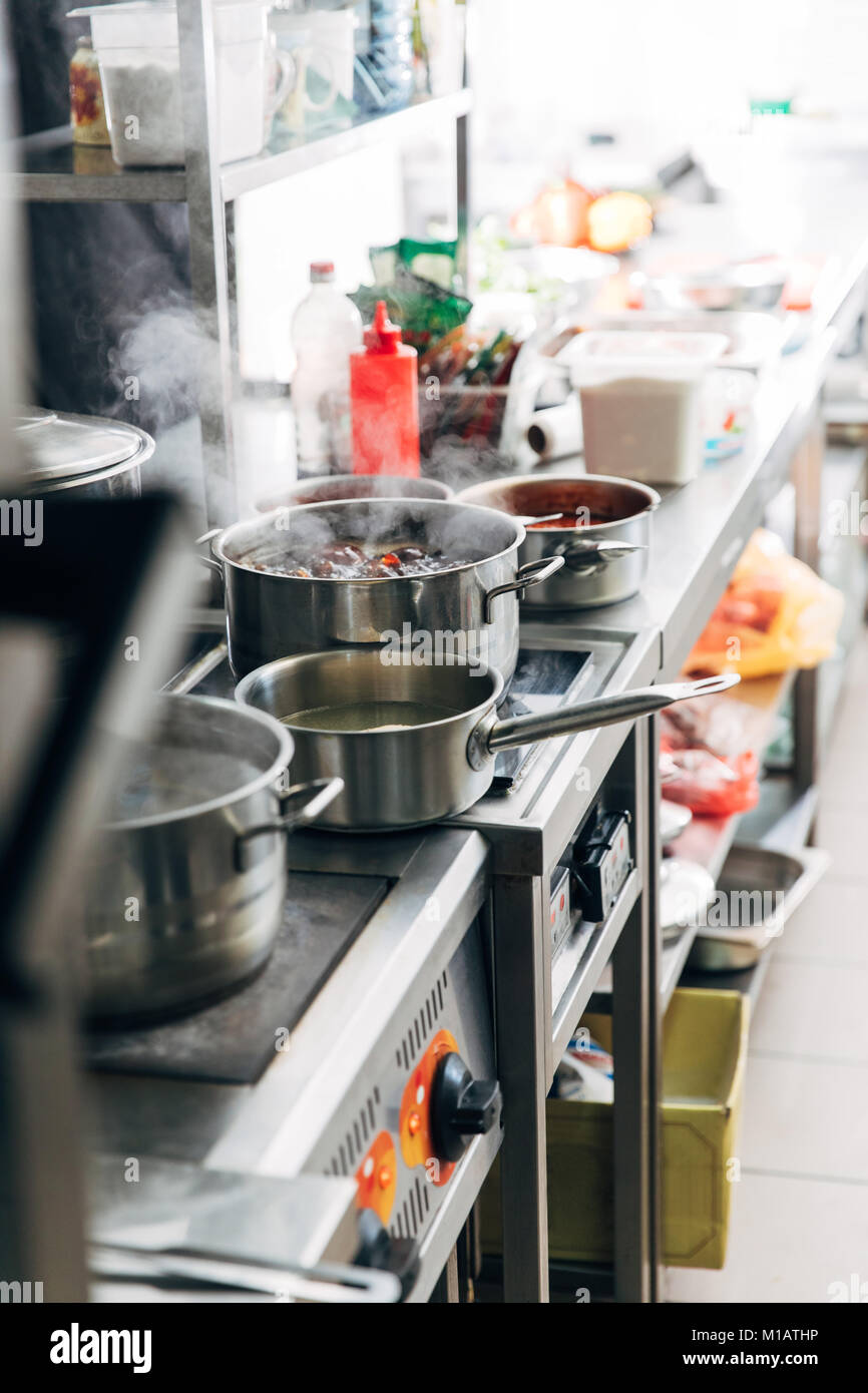 variation of dishes boiling in sauce pans at restaurant kitchen Stock ...