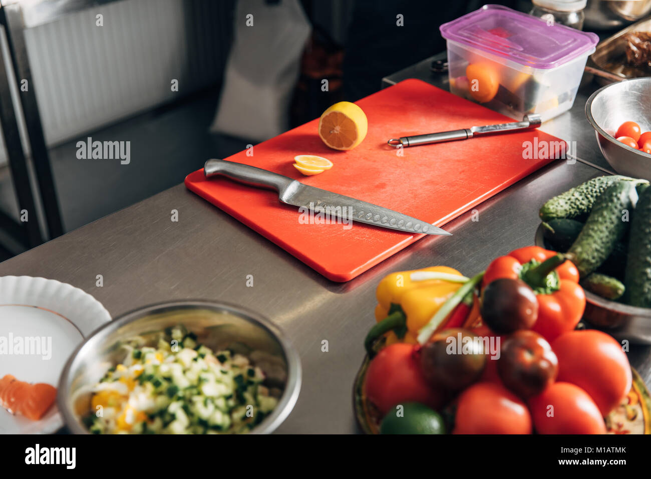 various ingredients and cutting board on table at restaurant kitchen ...