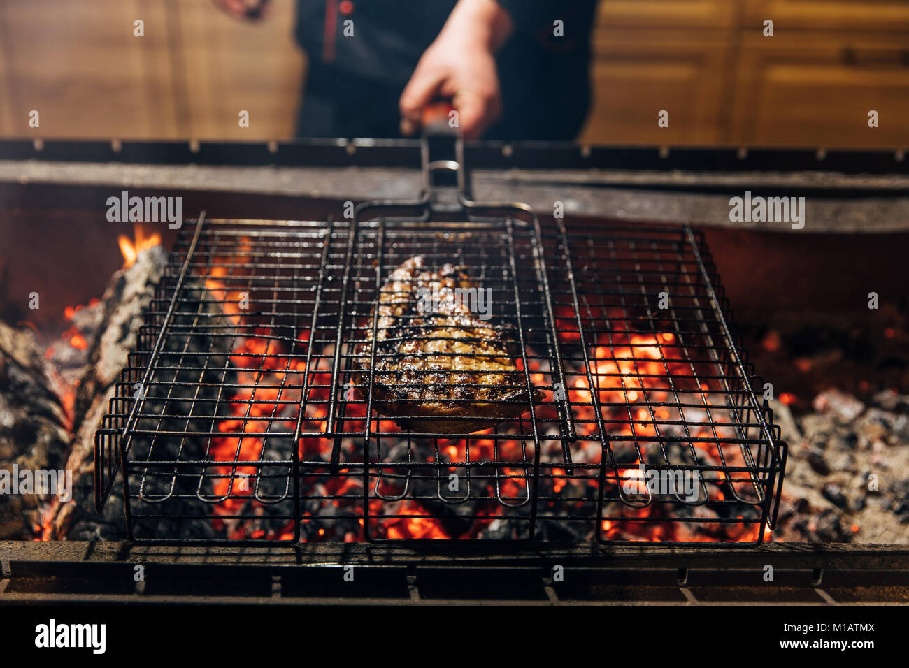cropped shot of chef grilling steak on flame Stock Photo - Alamy