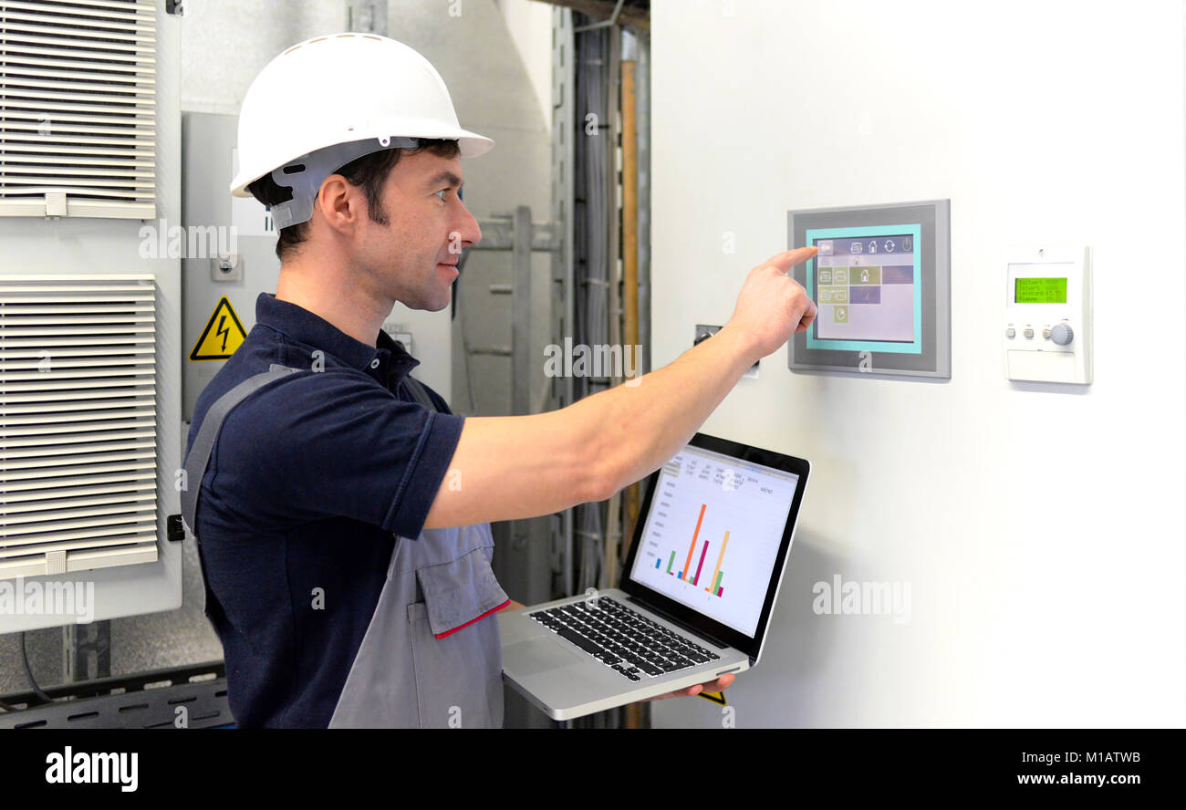 workers in an industrial plant check the systems with modern technology ...