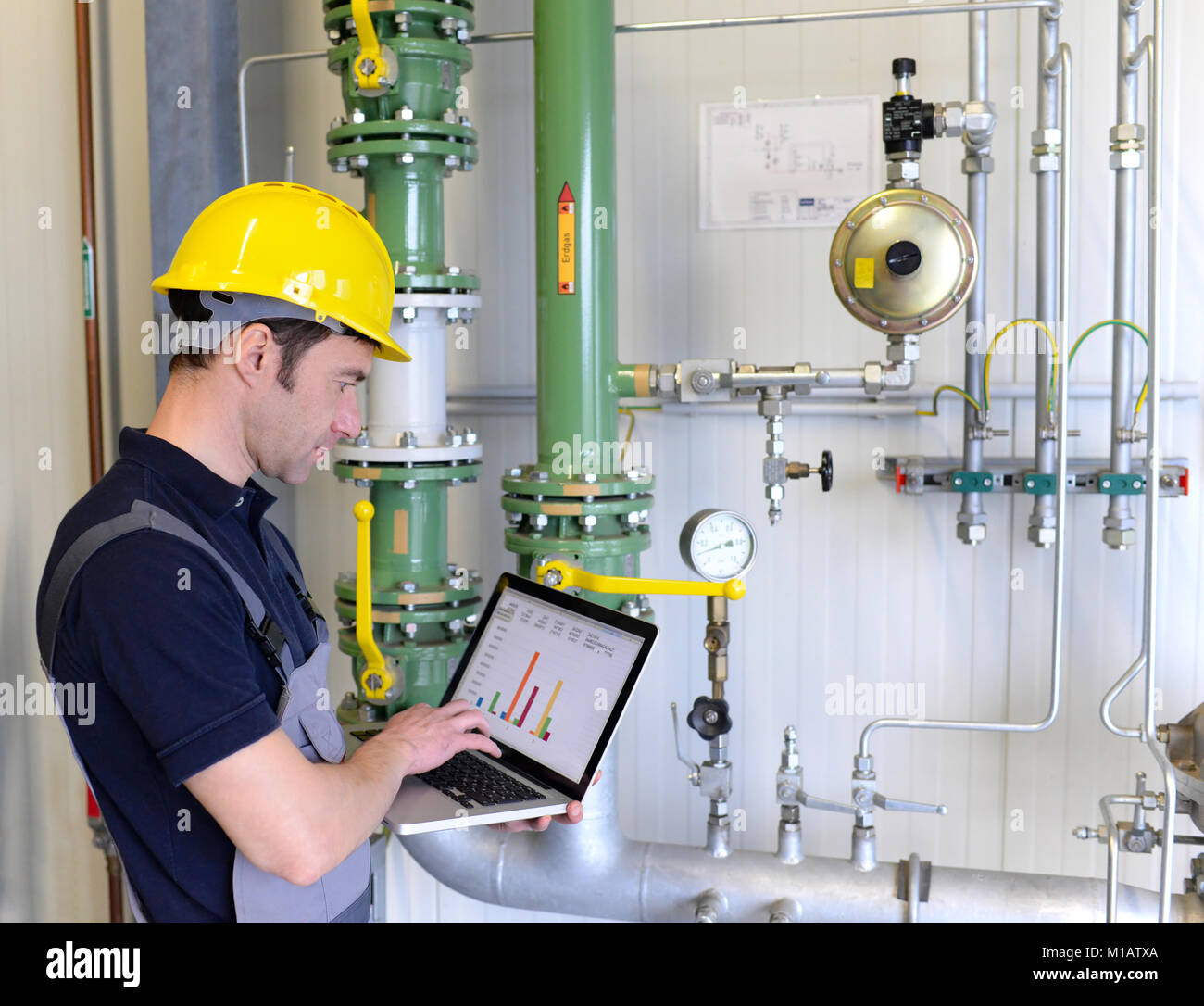 workers in an industrial plant check the systems with modern technology ...