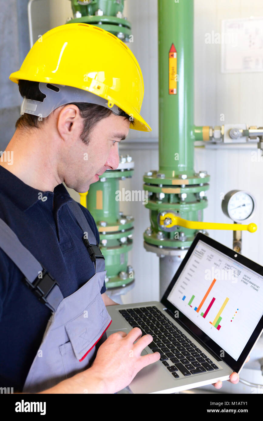 workers in an industrial plant check the systems with modern technology ...
