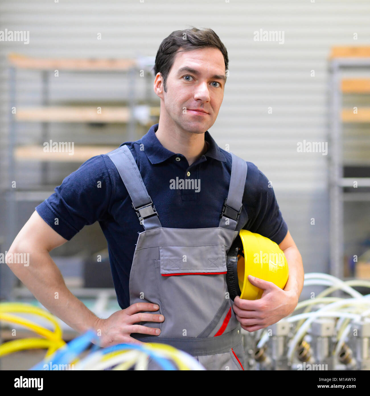 portrait of successful workman in an industrial company, in working ...